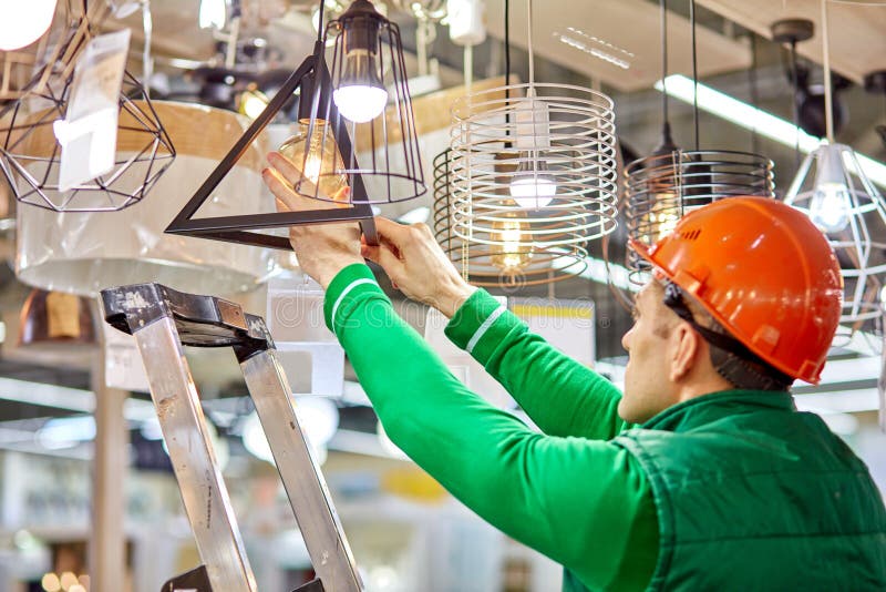 Warehouse Worker the Bulb into the Lamp Using a Stepladder Stock Image ...