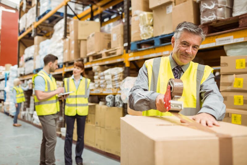Warehouse Worker Sealing Cardboard Boxes for Shipping Stock Image ...