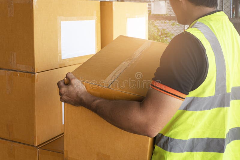Warehouse Worker Stcking Cardboard Boxes at Storage Warehouse. Shipment ...