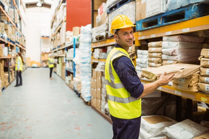 Warehouse Worker Taking Package in the Shelf Stock Image - Image of ...