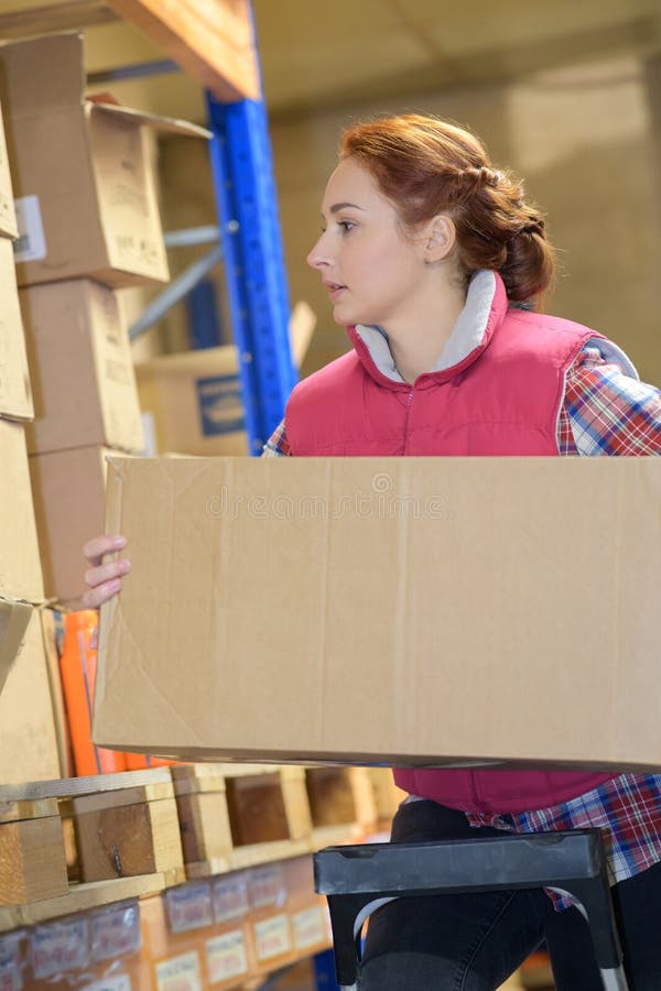Warehouse Worker Taking Package in Shelf in Warehouse Stock Photo ...