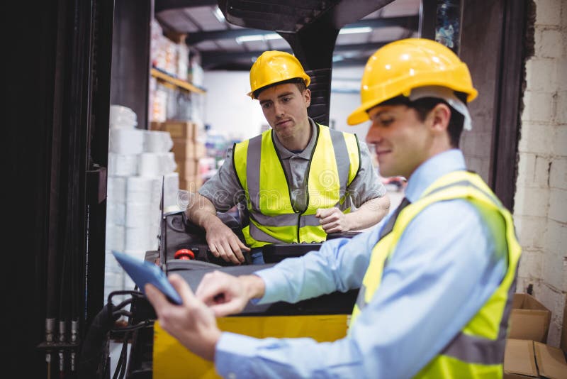Warehouse Worker Talking with Forklift Driver Stock Image - Image of ...