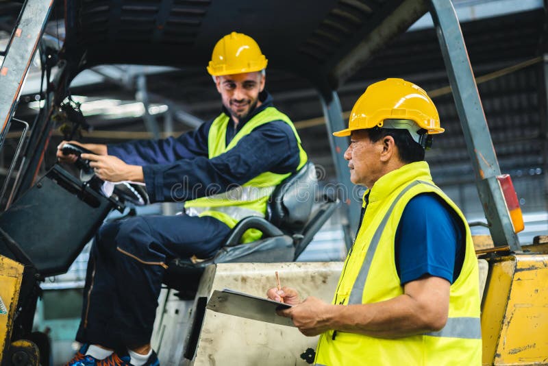 Warehouse Worker Talking with Forklift Operator in Factory Stock Photo ...