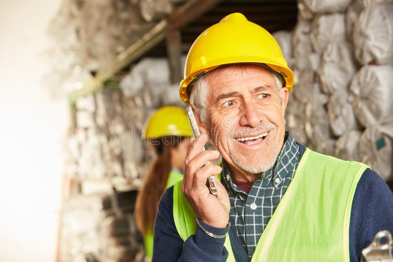 Warehouse Worker is Talking on a Mobile Phone Stock Image - Image of ...