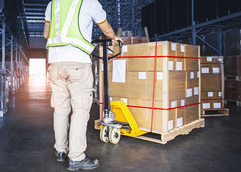 Warehouse Worker Unloading Hand Pallet Jack with Package Boxes. Supply ...