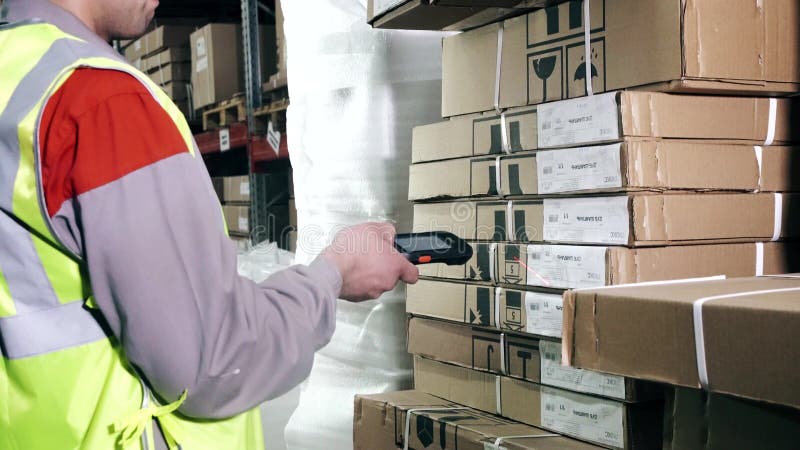 A Warehouse Worker Uses a Barcode Scanner Stock Video - Video of ...