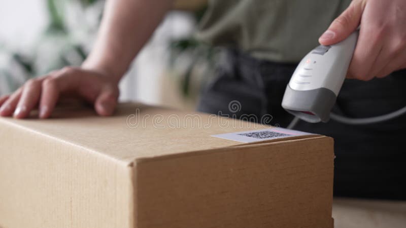 Warehouse Worker Using a QR Code Reader, Scanning Parcels into the ...