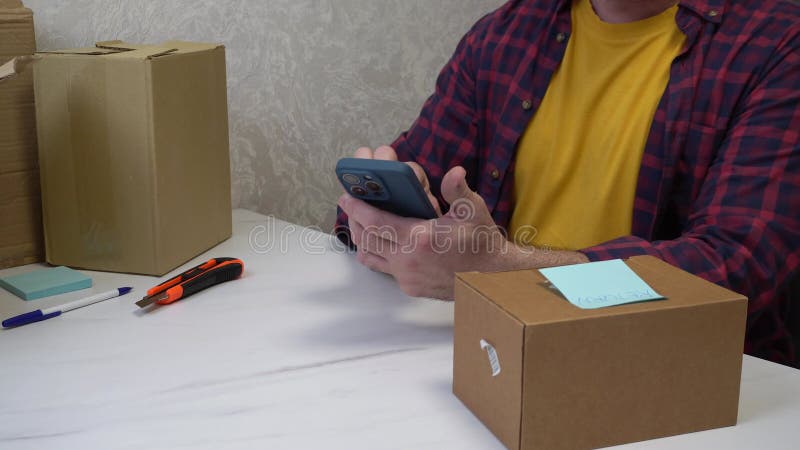 Warehouse Worker Using Smartphone To Manage Inventory and Cardboard ...
