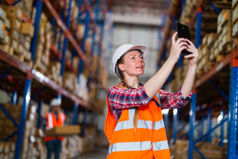 Warehouse Worker Working Process Checking the Package Using a Tablet in ...
