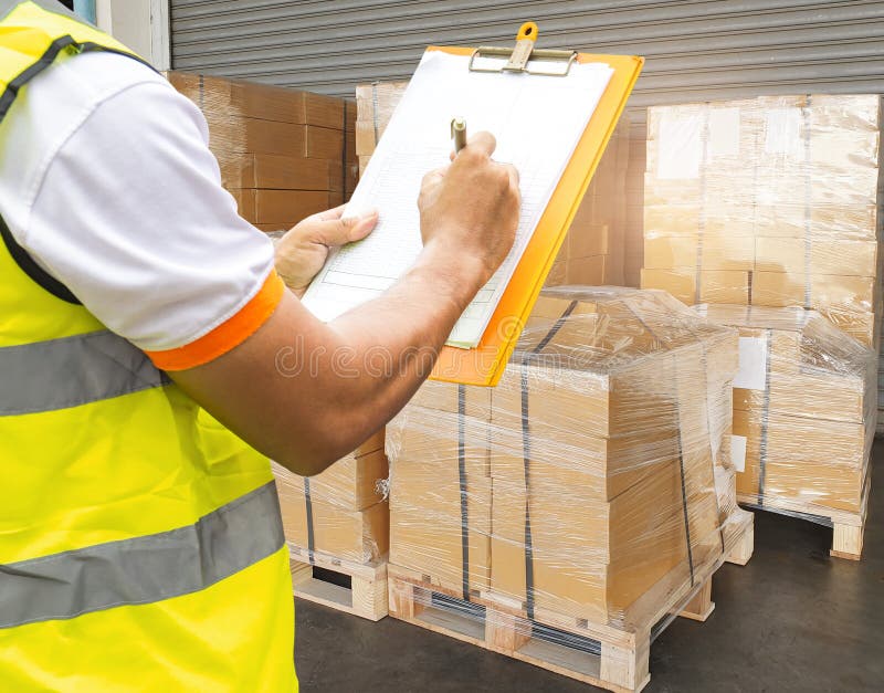 Warehouse Worker Writing on Paper Clipboard, His Checking Order ...