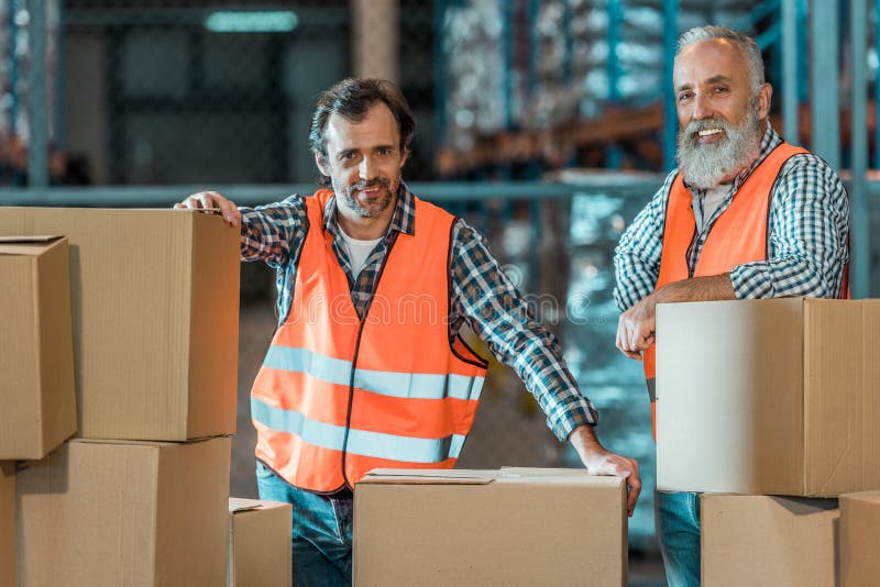 Cheerful Warehouse Workers Standing with Boxes and Smiling Stock Image ...