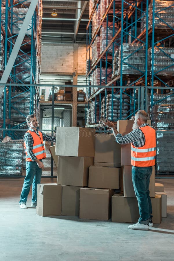 Full Length View of Two Warehouse Workers Working with Boxes Stock ...