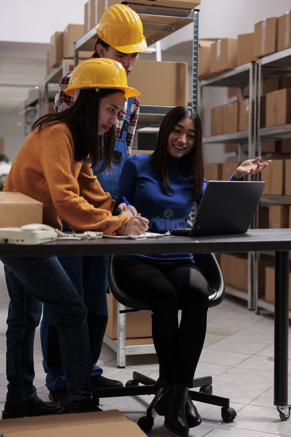 Warehouse Workers Checking Order Pick Ticket on Laptop Stock Photo ...