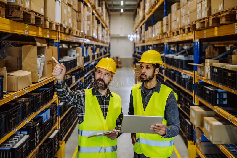 Warehouse Workers Checking Stuff in Warehouse with Digital System in ...
