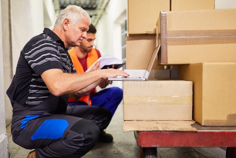Warehouse Workers at the Computer Plan Package Shipping Stock Photo ...