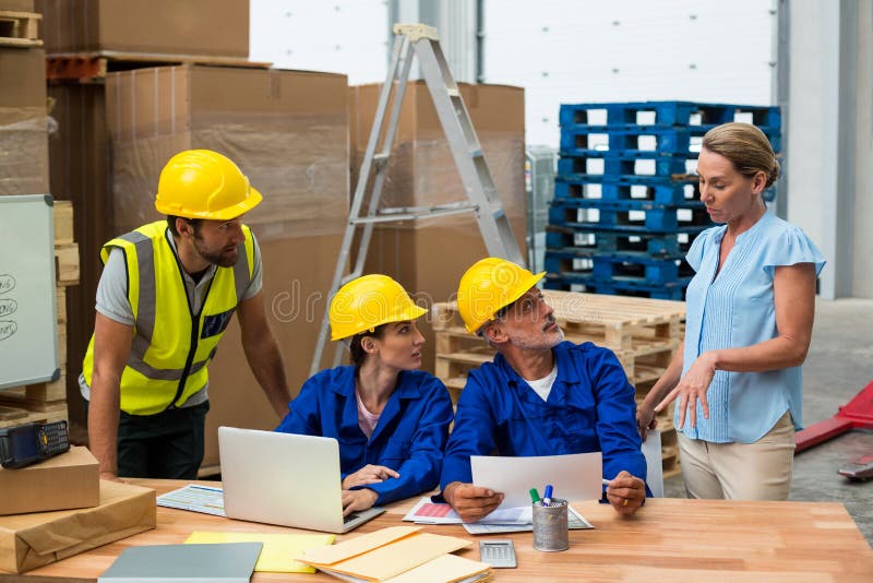 Warehouse Managers Interacting with Workers Stock Photo - Image of ...