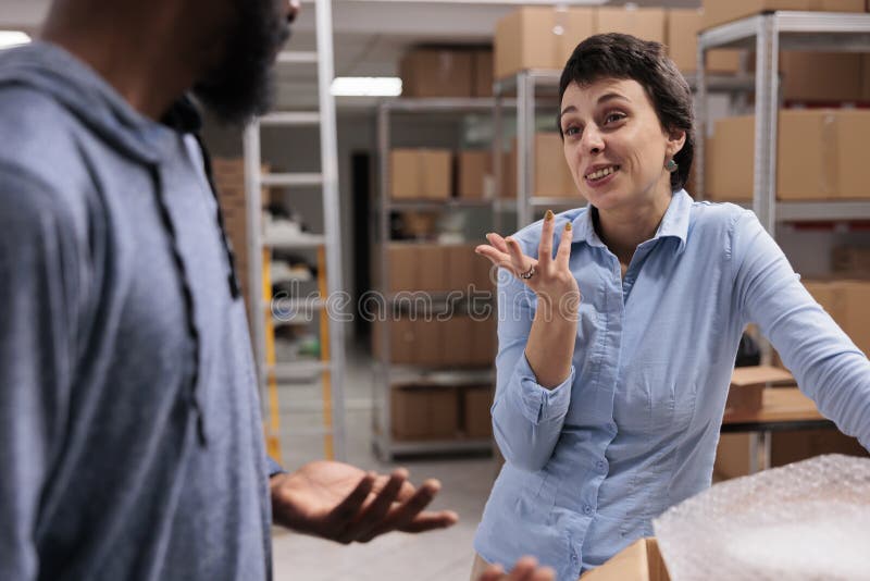 Warehouse Workers Discussing about Packaging Inventory while Putting ...