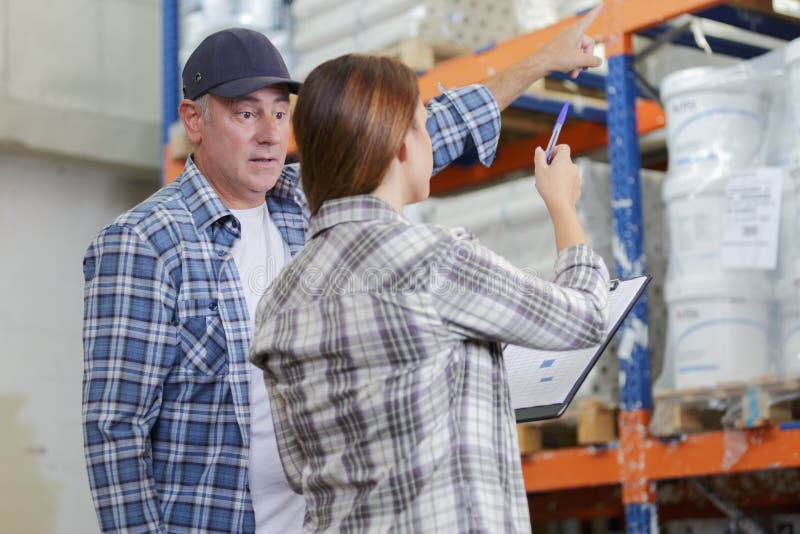 Warehouse Workers Doing Inventory in Paint Hardware Store Stock Image ...