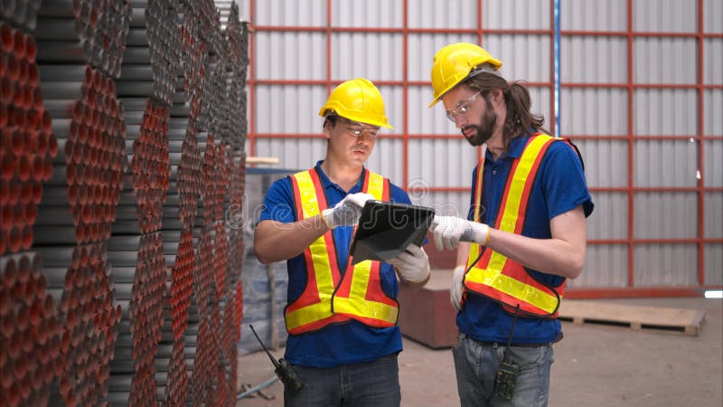 Warehouse Workers in Hard Hats and Helmets, Inspect and Count Steel ...