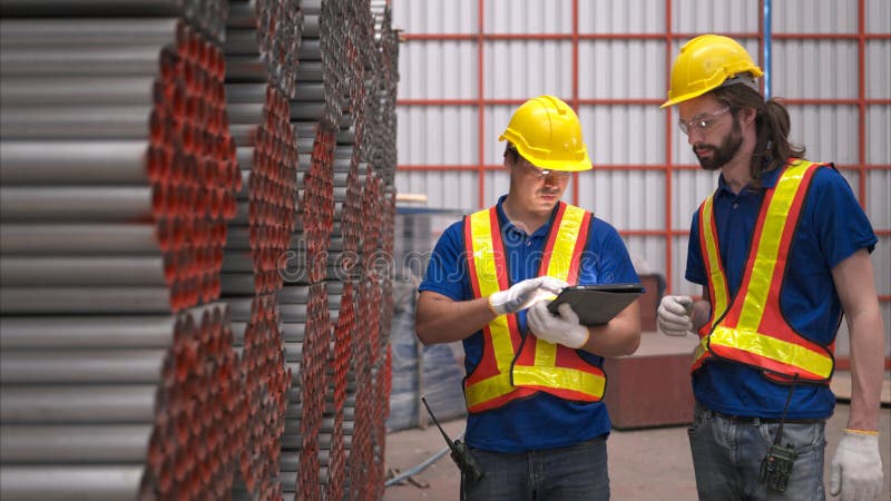 Warehouse Workers in Hard Hats and Helmets, Inspect and Count Steel ...