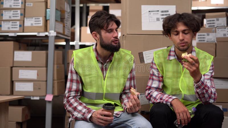 Warehouse Workers Having Lunch at Workplace, Communicating and Eating ...