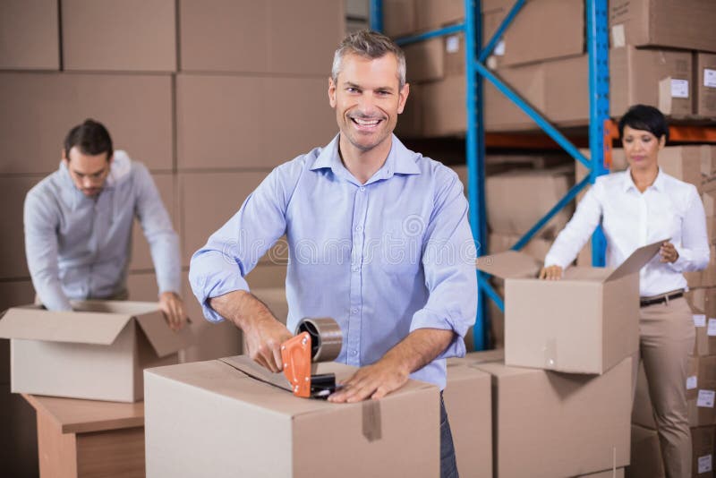 Warehouse Workers Packing Up Boxes Stock Image - Image of mixedrace ...