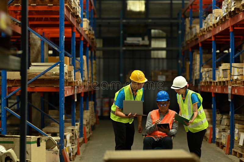 Warehouse Workers in Safety Uniform Working in Warehouse Full of Tall ...