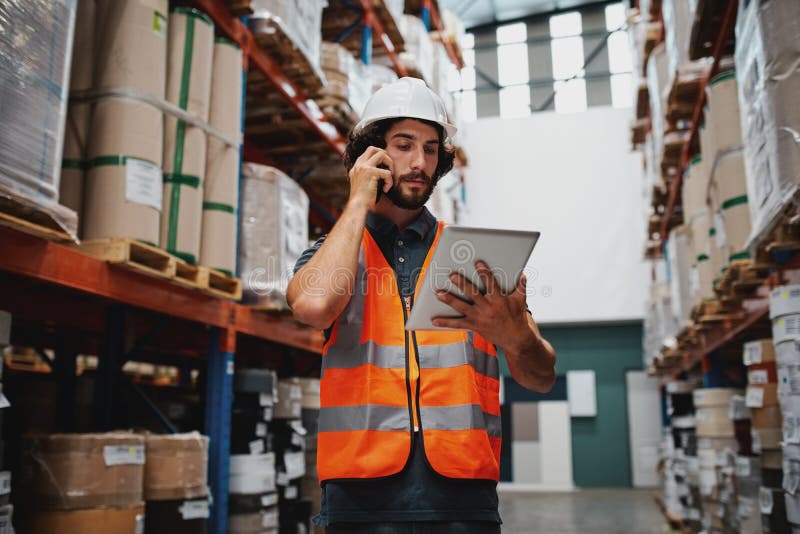 Warehouse Working Holding Digital Tablet while Talking Over Mobile ...