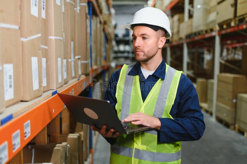 Warehouseman Checking Delivery, Stock in Warehouse on Laptop. Warehouse ...