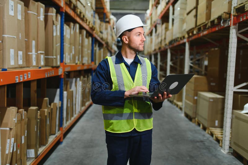 Warehouseman Checking Delivery, Stock in Warehouse on Laptop. Warehouse ...