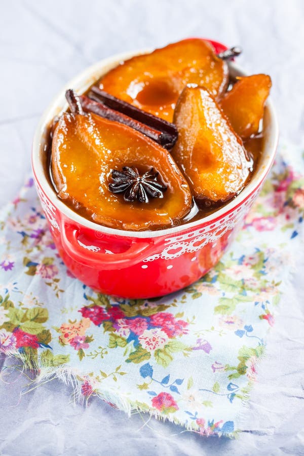 Warm Caramel Pears with Cinnamon and Star Anise in a Red Pot Stock ...
