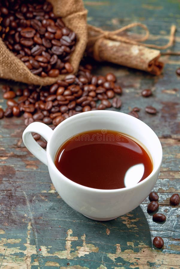 Warm Coffee Cup with Roasted Beans on Rustic Table Stock Photo - Image ...