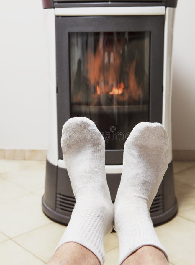 Warm feet in front of fire stock photo. Image of relaxing - 82589982