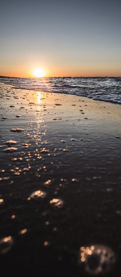 The Warm Orange Sunset Sun is Reflected in the Mirror Surface of the ...