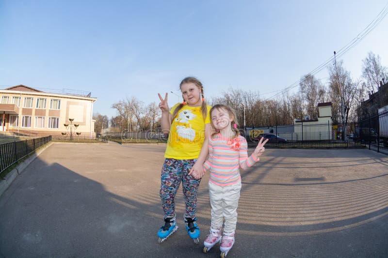 On a Warm Spring Evening, the Girls Rollerblade. Stock Image - Image of ...