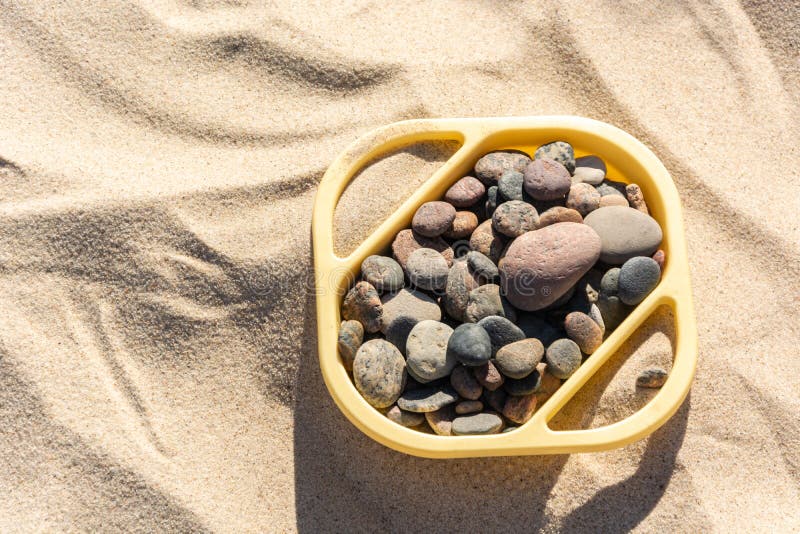 Warm Stones in Box on the Yellow Sand on the Beach Stock Image - Image ...