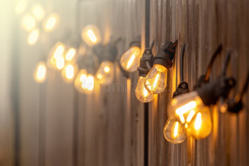 Warm String Lights Glow Softly Against a Wooden Wall, Creating a Cozy ...