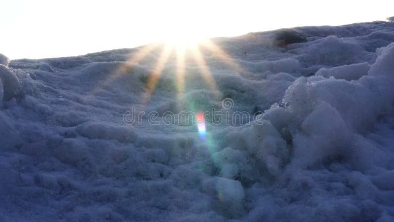 The Warm Sun Shines through the Cold Snow-covered Mountains in the ...