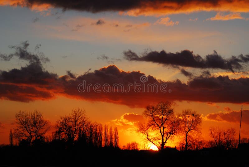 Warm Sunset with Clouds and Trees Stock Image - Image of shining ...