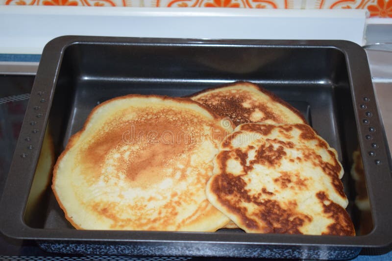 Pancakes in a baking form stock image. Image of sizes - 316014357