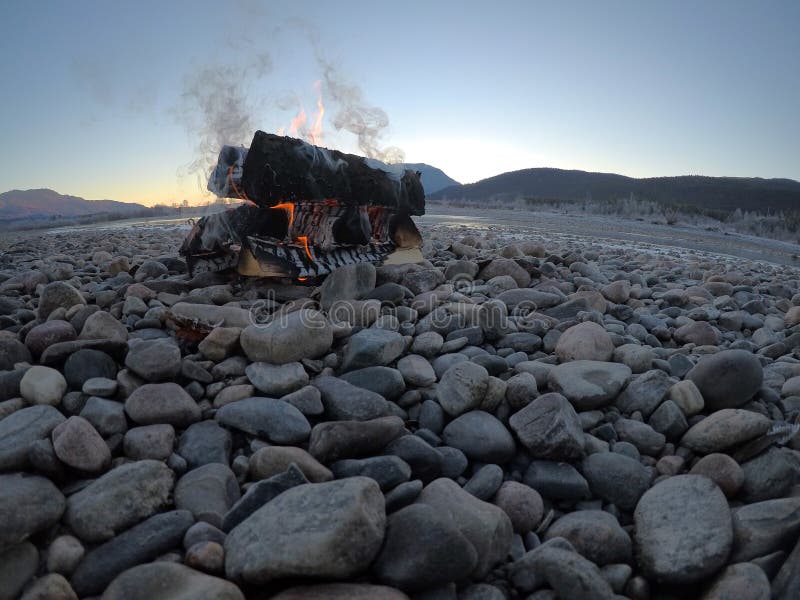 Warming Fire on Cold Rocky River Shore in Early Winter Stock Photo ...
