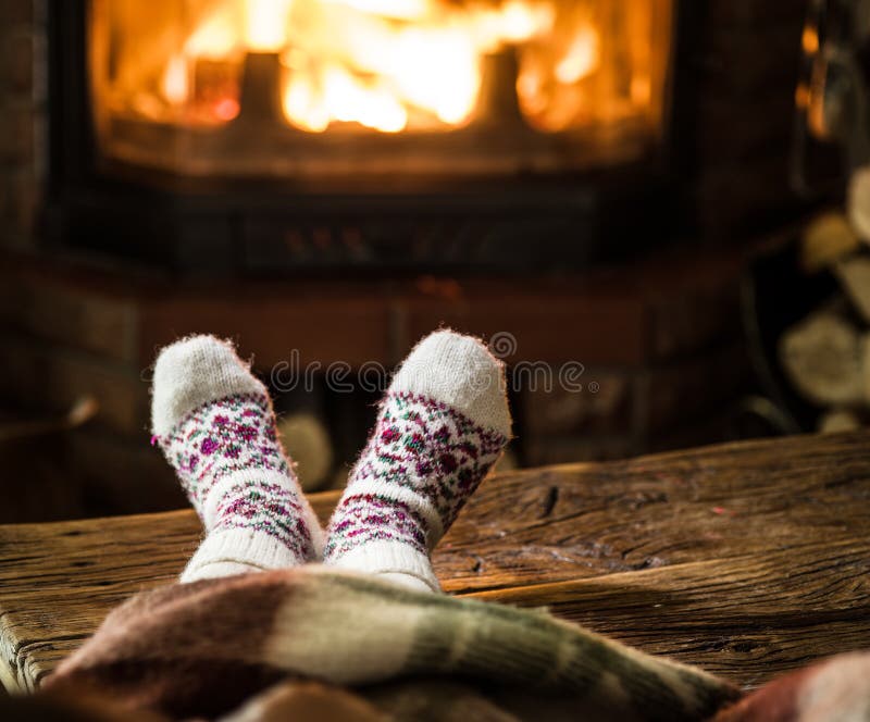 Warming and Relaxing Near Fireplace. Child Feet in Front of Fire Stock ...