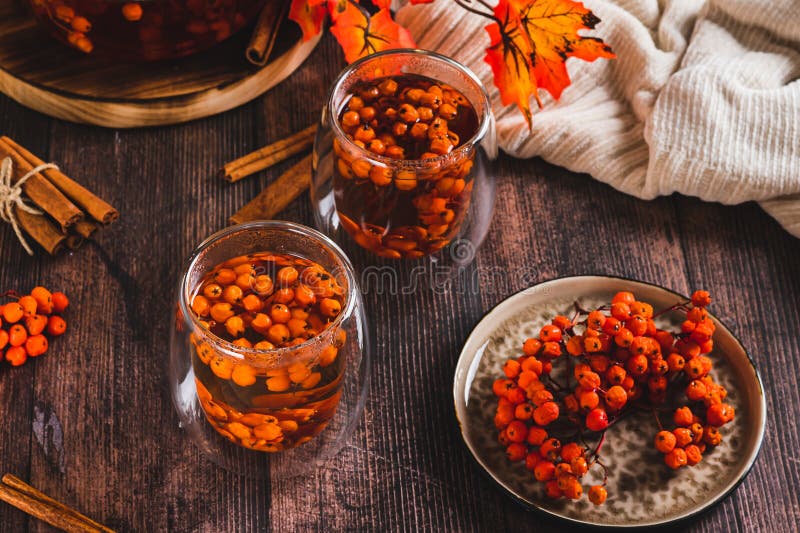 Warming Rowan Tea with Cinnamon in Glasses and a Teapot on the Table ...
