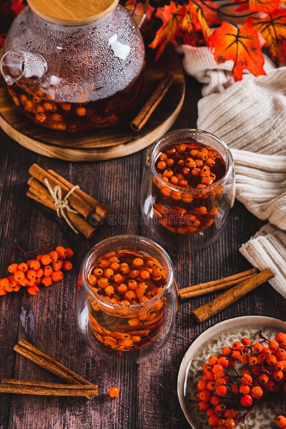 Warming Rowan Tea with Cinnamon in Glasses and a Teapot on the Table ...