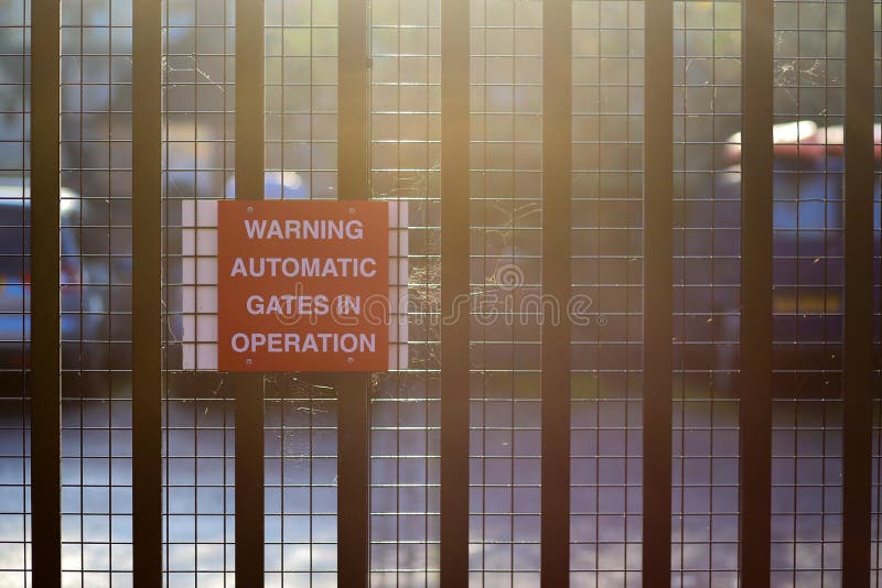 Warning Automatic Gates in Operation, Red Sign on Metal Gate Stock ...