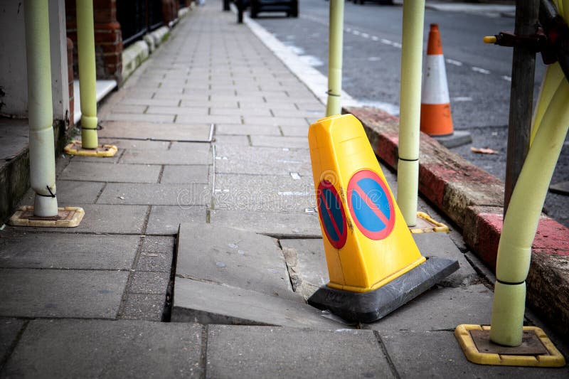 Warning Cone on Damaged Pedestrian Sidewalk. Construction Site and ...