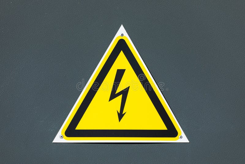 Warning Electrical Triangle Sign or Table on Grey or Brown Background ...