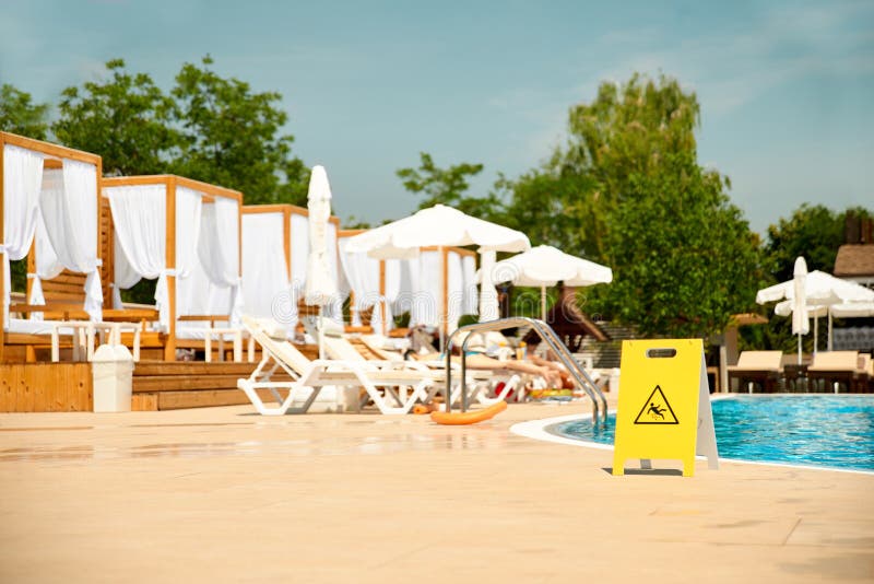 Warning Plates Wet Floor beside the Pool Made of Yellow Plastic. Stock ...