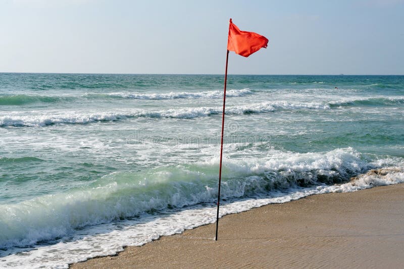 A Warning Red Flag of Danger at Sea Stock Photo - Image of cloudy ...