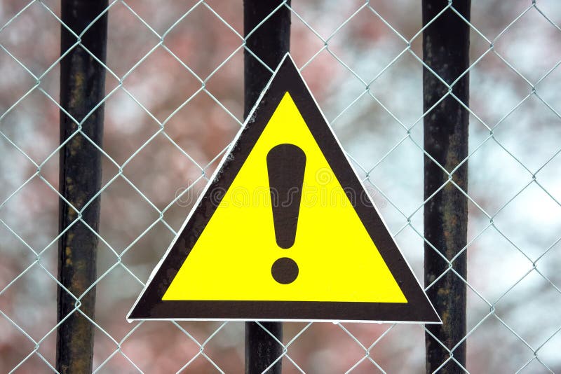 Warning Sign in the Form of a Triangle on a Metal Mesh Fence Stock ...